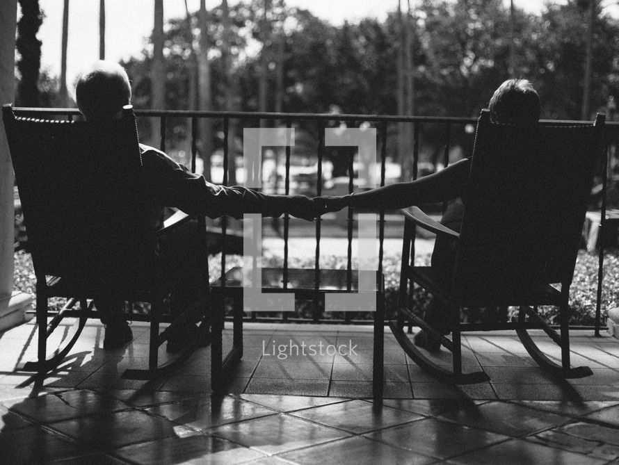 Stock Photo - Couple in rocking chairs holding hands on a porch by ...
