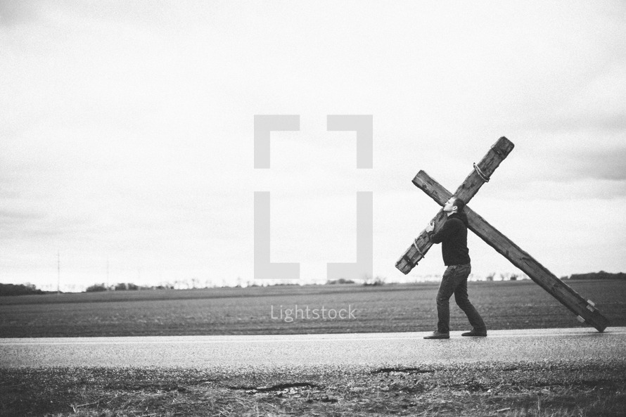 Stock Photo - Man carrying a large cross along the highway -... by ...