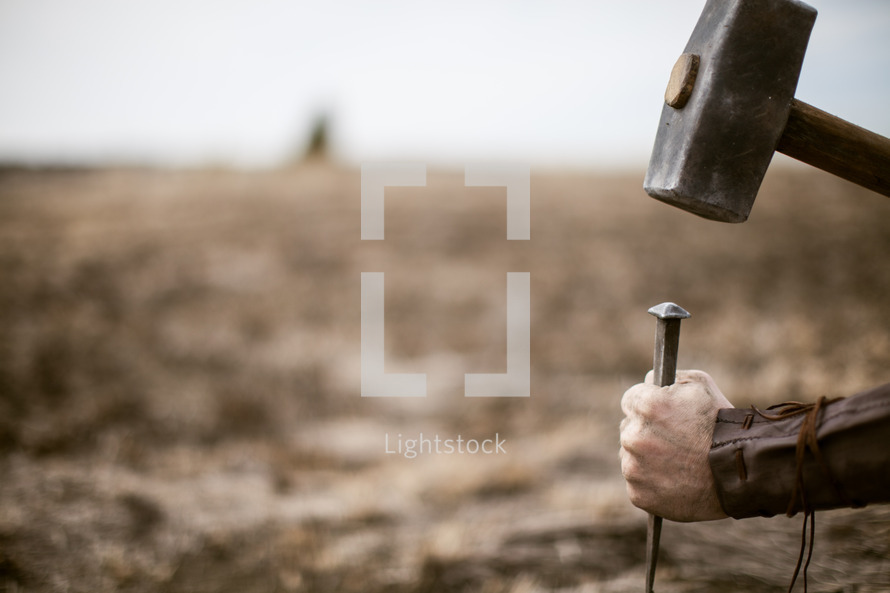 Stock Photo - Roman soldier hammering nail into the cross. by Pearl ...